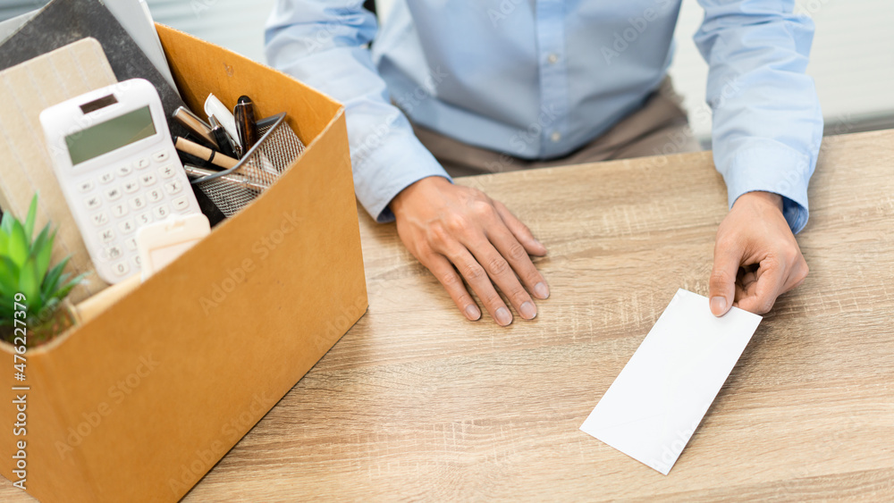Resignation Concept The male officer sitting, putting his box of his ...