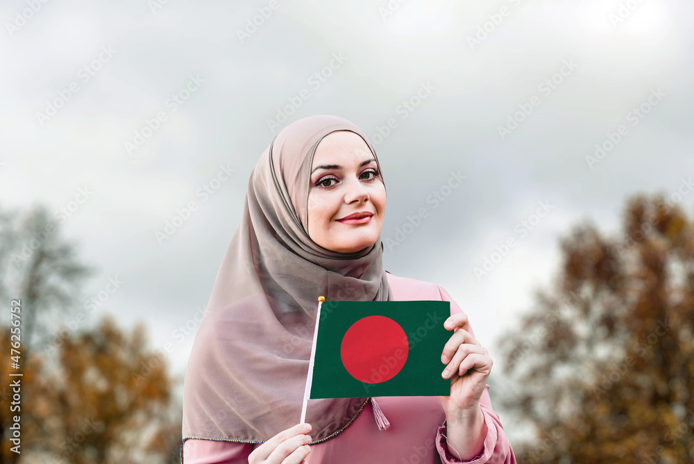 Muslim woman in hijab holds flag of Bangladesh Stock Photo | Adobe Stock