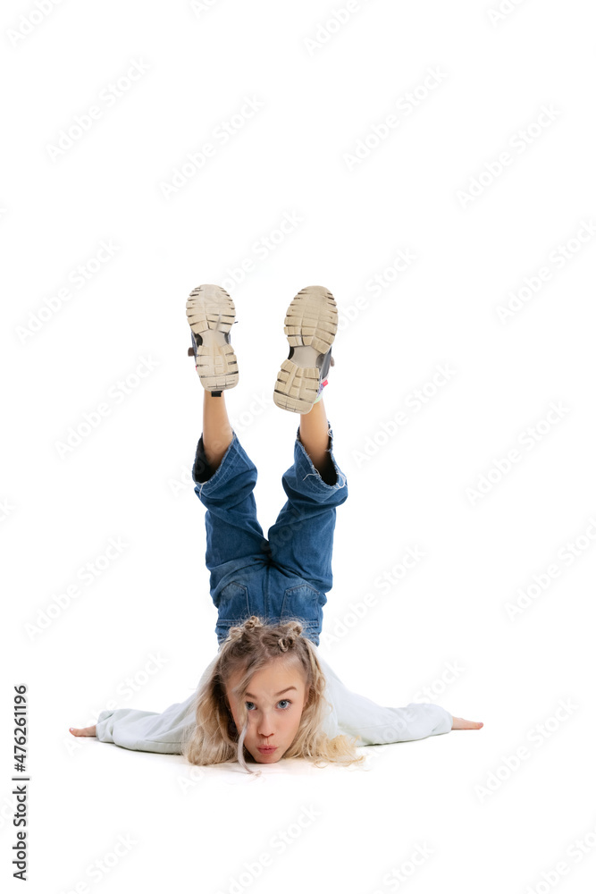Cute funny little girl, flexible kid in casual clothes having fun ...