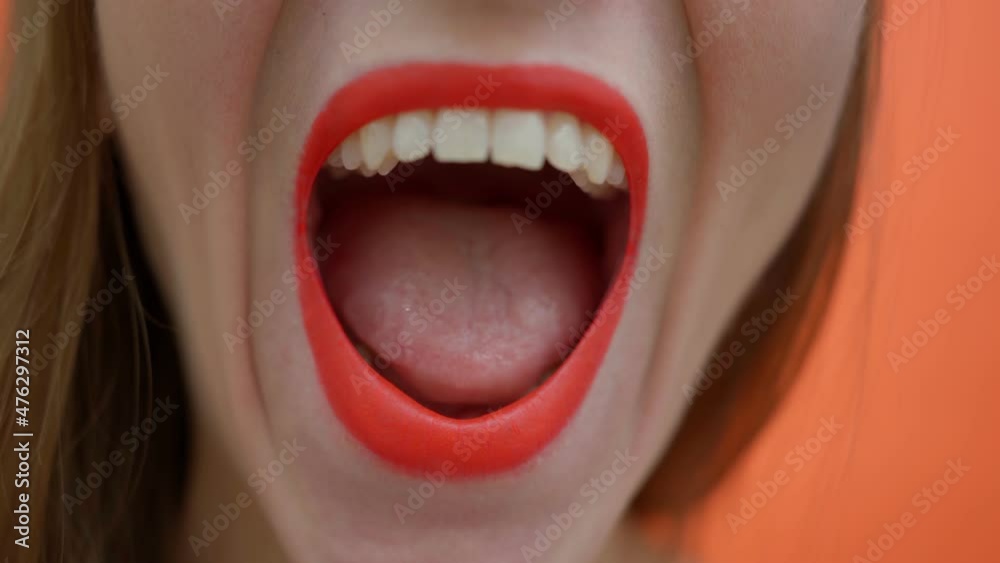 woman with red lipstick on her lips is screaming loudly. Red lips with ...