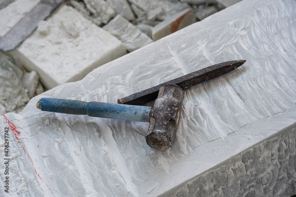 Sculptor tools on a marble slab, close up. Workplace, traditional tools ...