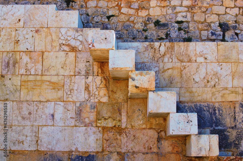 Ancient marble steps in the marble wall of Kizkalesi fortress. Worn ...