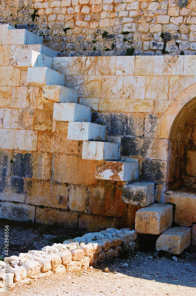 Old marble steps in the marble wall of ancient Kizkalesi fortress. Worn ...