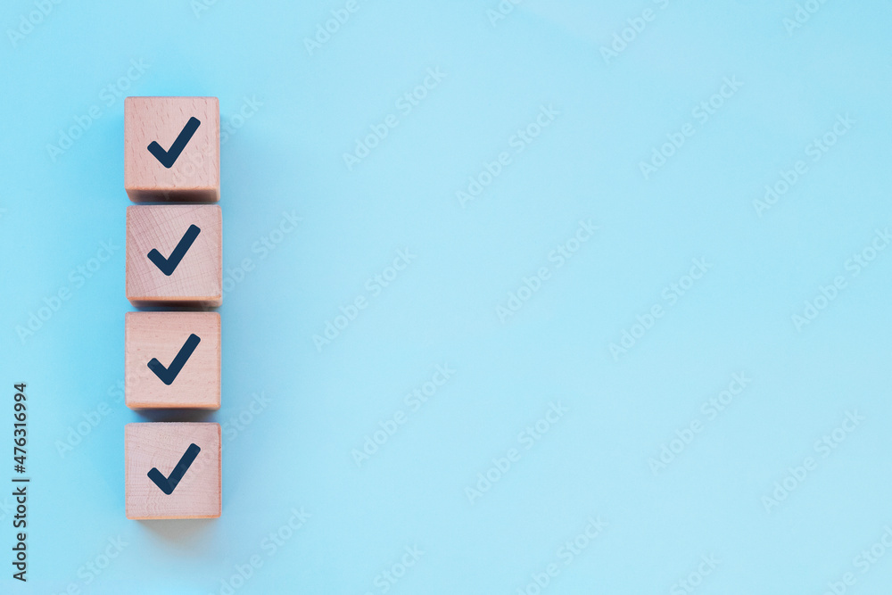 Checklist concept, Check marks on wooden cube blocks, blue background ...