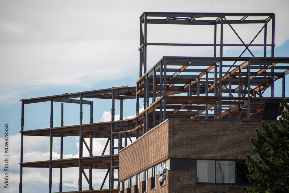 The exterior construction of a large multi-story high-rise building ...