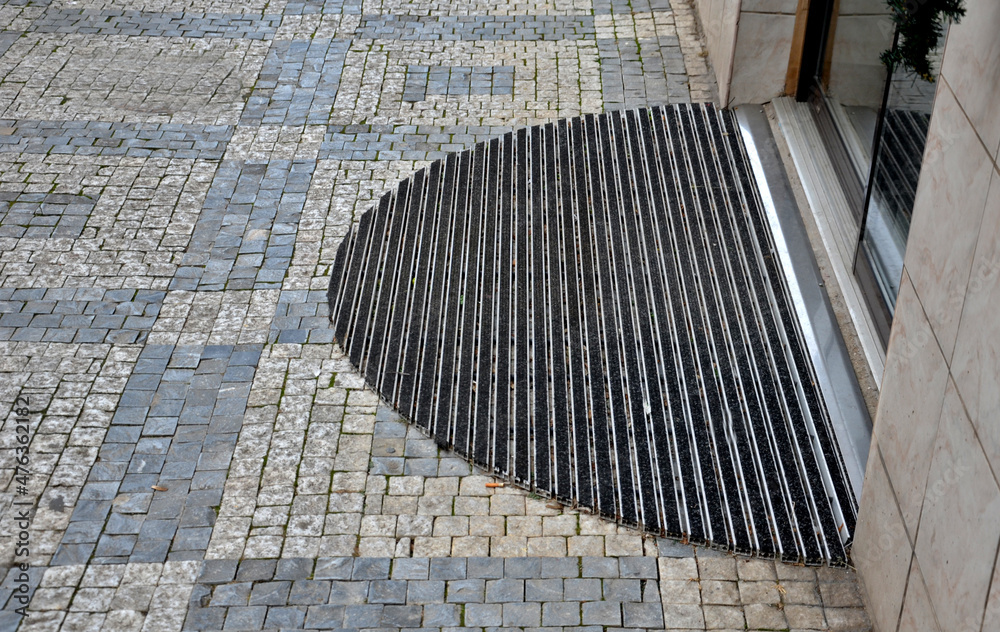 industrial mat cleaning zones at the entrance to the building. A black ...