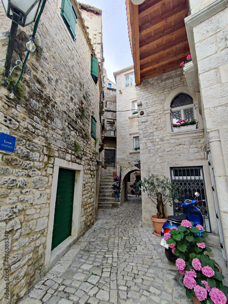 Streets of historic and tourist town of Hvar with fort, port and yacht ...