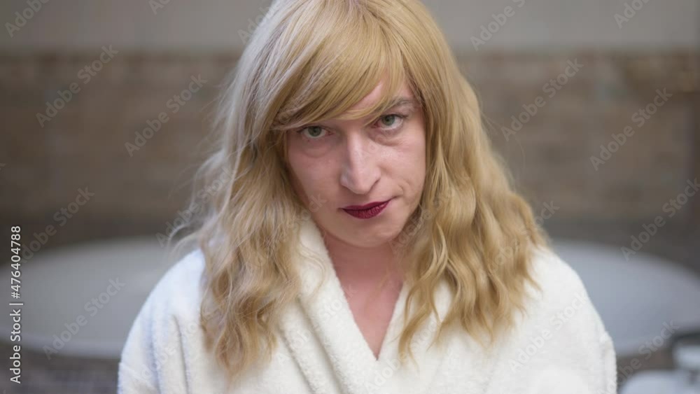 Upset Caucasian transgender woman looking at camera with sad facial ...