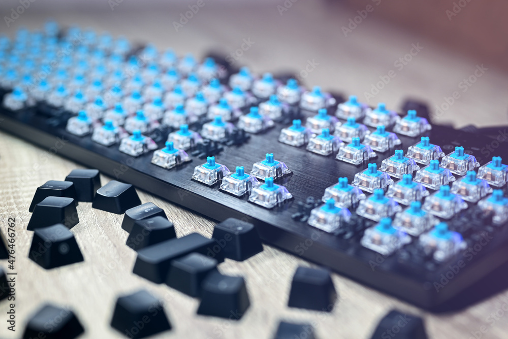 Disassembled black gaming mechanical keyboard. The keycaps are ...