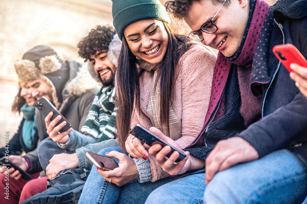 Teenagers group watching smart phones mobile outdoors - Diverse ...