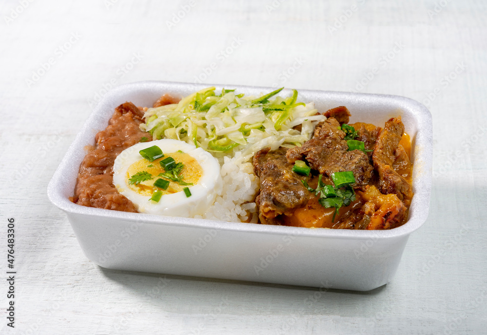 food delivery, styrofoam lunch box with beef meat cooked with cassava ...