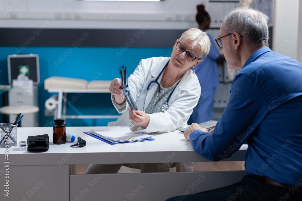 Specialist explaining radiography diagnosis to patient with disease at ...