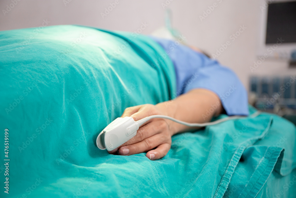 Closeup pulse oximeter with finger of patient at hospital, cardiology ...