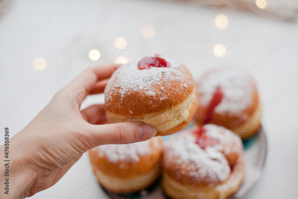 Sufganiyot donuts with icing sugar and red jelly. Israeli jelly donuts ...