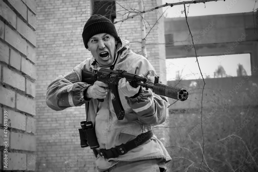 Armed soldier aim from a machine gun. A man in uniform with a ...