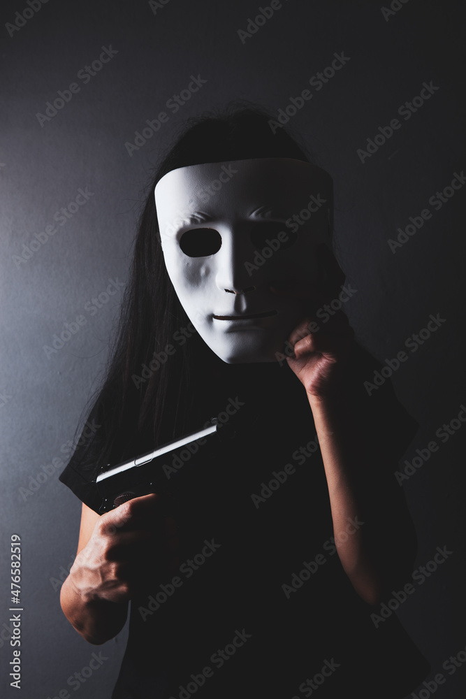 masked girl holding a gun Stock Photo | Adobe Stock
