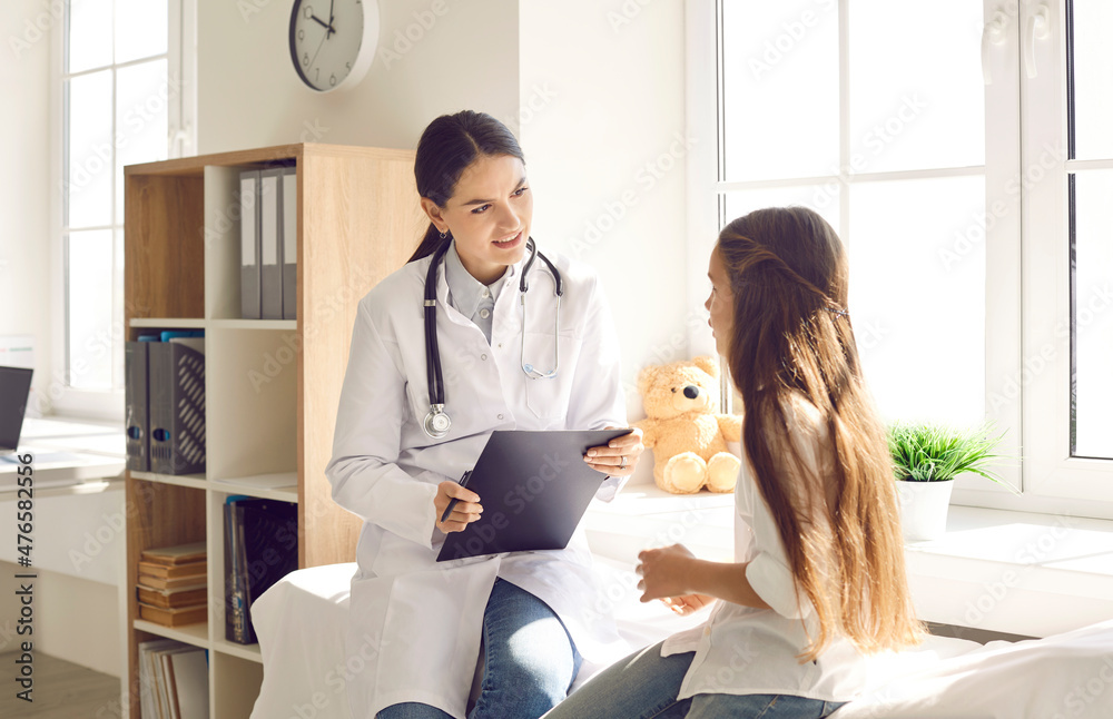 Child talking to a doctor. Pediatrician listening to a kid during a ...