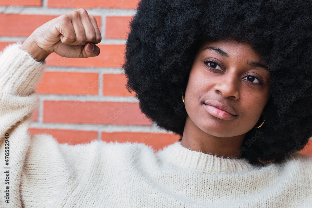 Closeup of african american woman with long afro hair showing arm ...