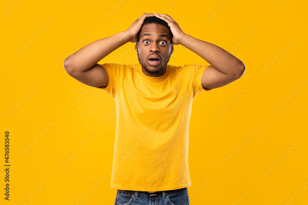 Foto de Black Man Touching Head In Shock Posing Over Yellow Background ...