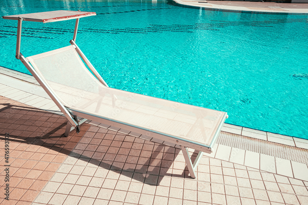 Resort pool. Summer resort chair, relax lounge at luxury hotel pool ...