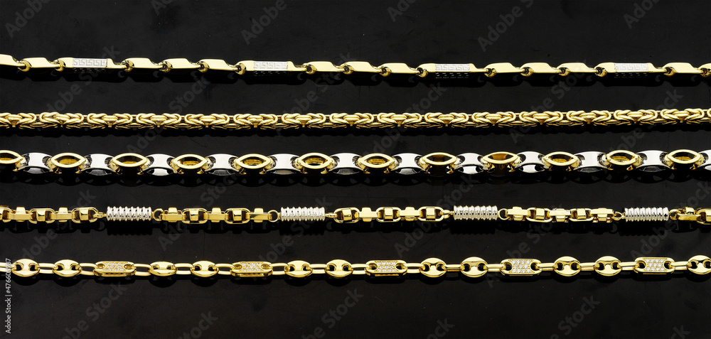 Gold jewellery. Gold chains on black background Stock Photo | Adobe Stock
