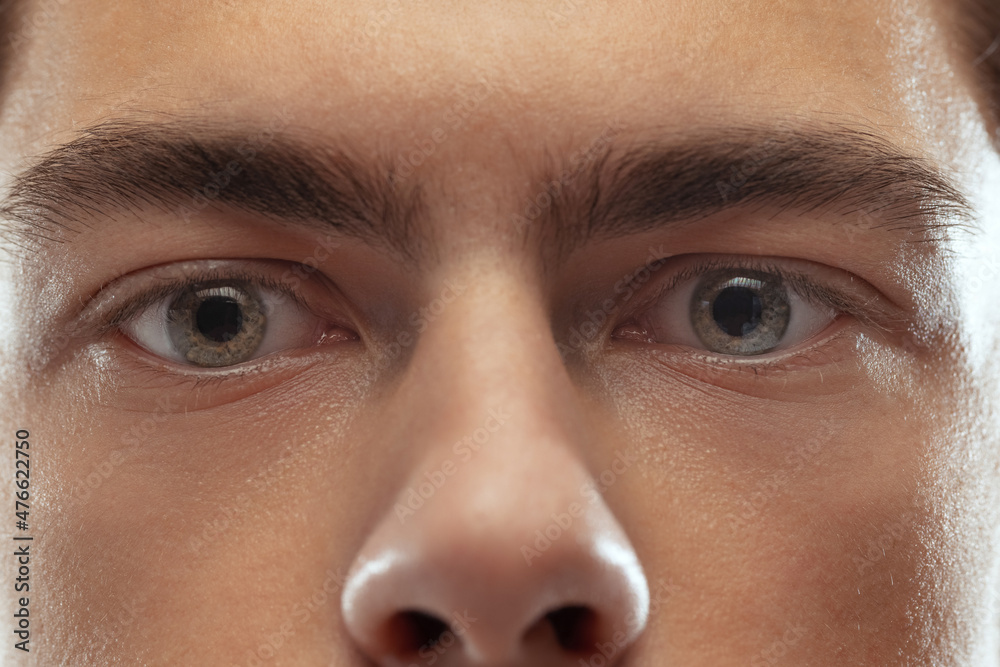 Foto de Blue eyes. Close-up upper face of young man. Man looking at ...