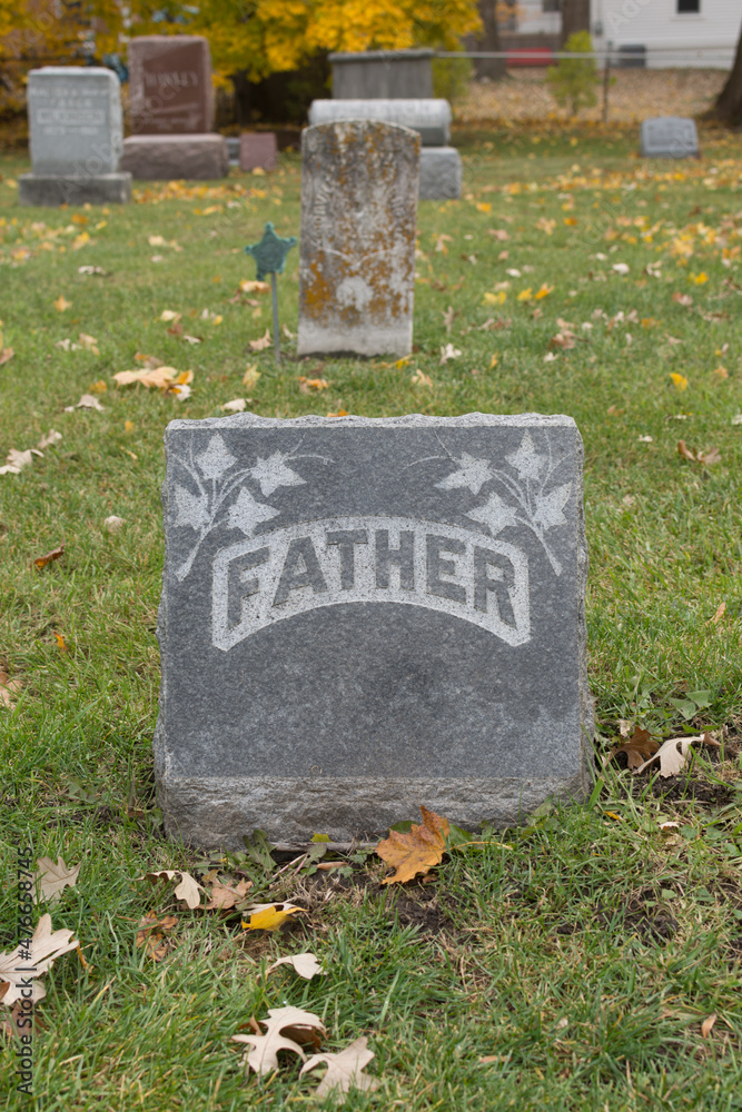 Gravestone that simply says "FATHER" with no other identification; ivy ...