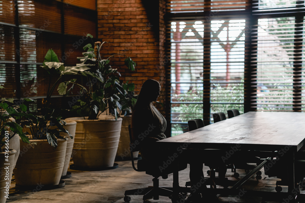 View of business office with one employee sitting at work alone. View ...