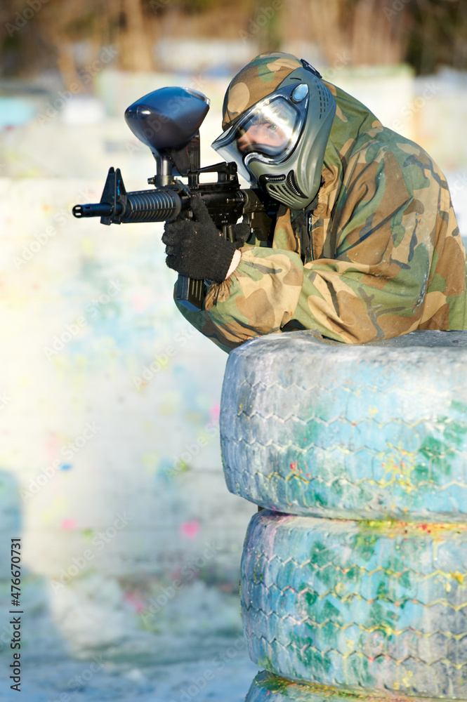 paintball player with marker at winter outdoors Stock Photo | Adobe Stock