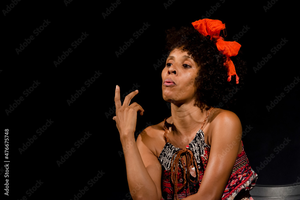 Actress on stage represents a dramatic character. She is sitting in a ...