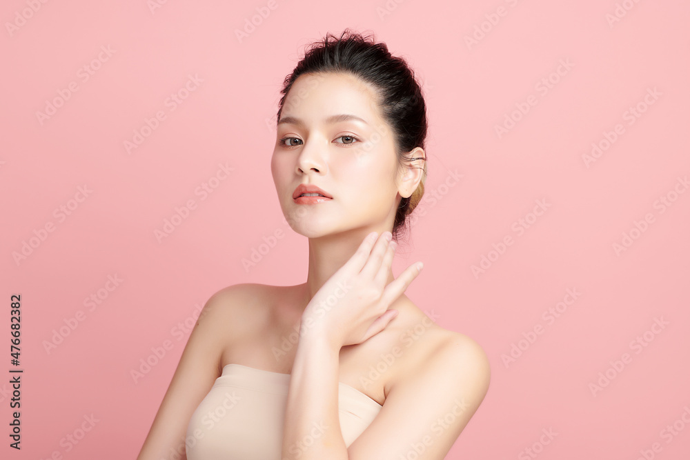Beautiful young asian woman with clean fresh skin on pink background ...