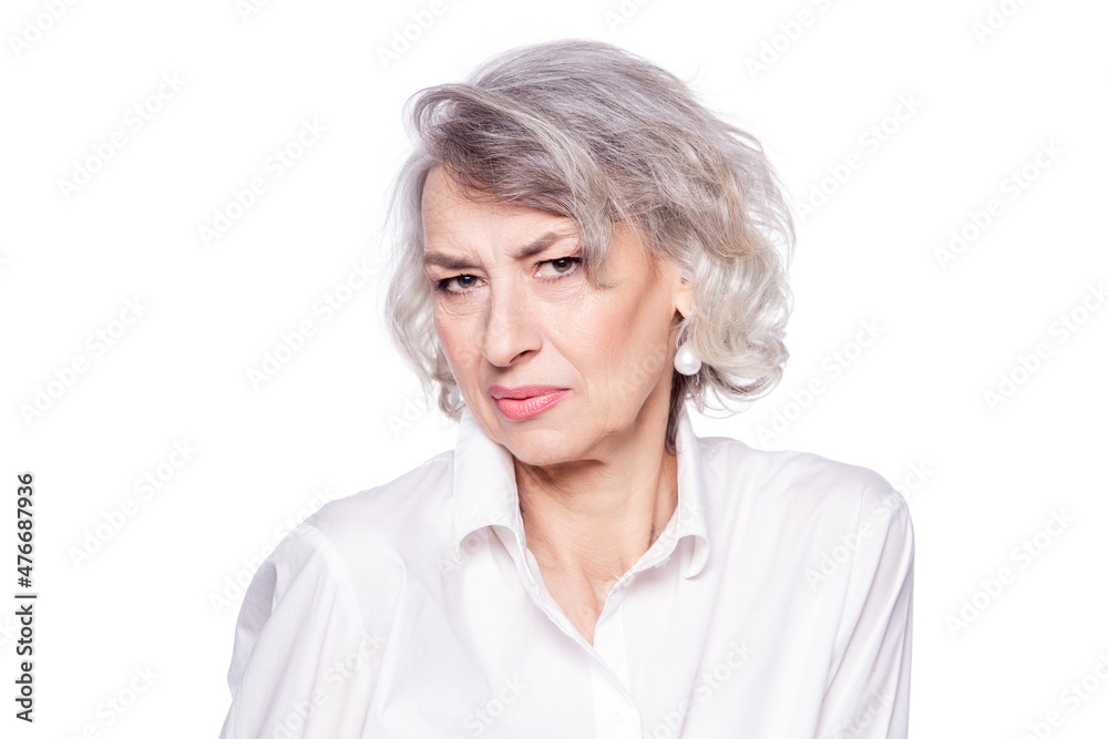 Displeased retired old woman with wrinkled well cared face looks ...