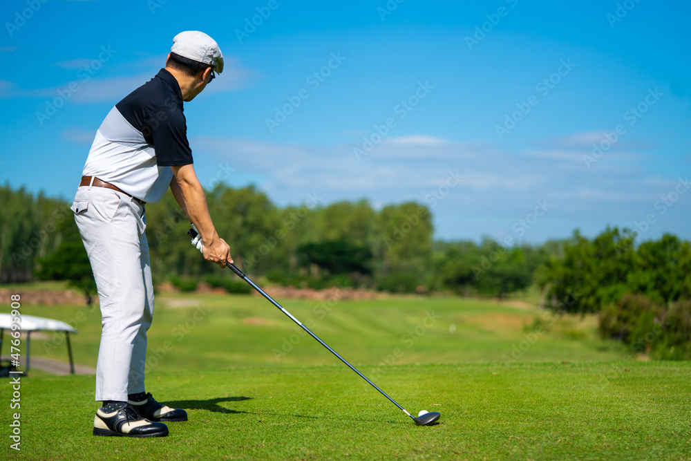 Confidence Asian man golfer holding golf club hitting golf ball on the ...