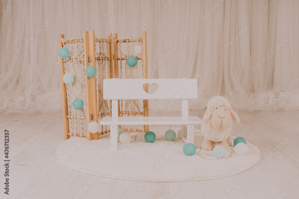 Mini bench with a sheep for a baby photo session in a photo studio ...
