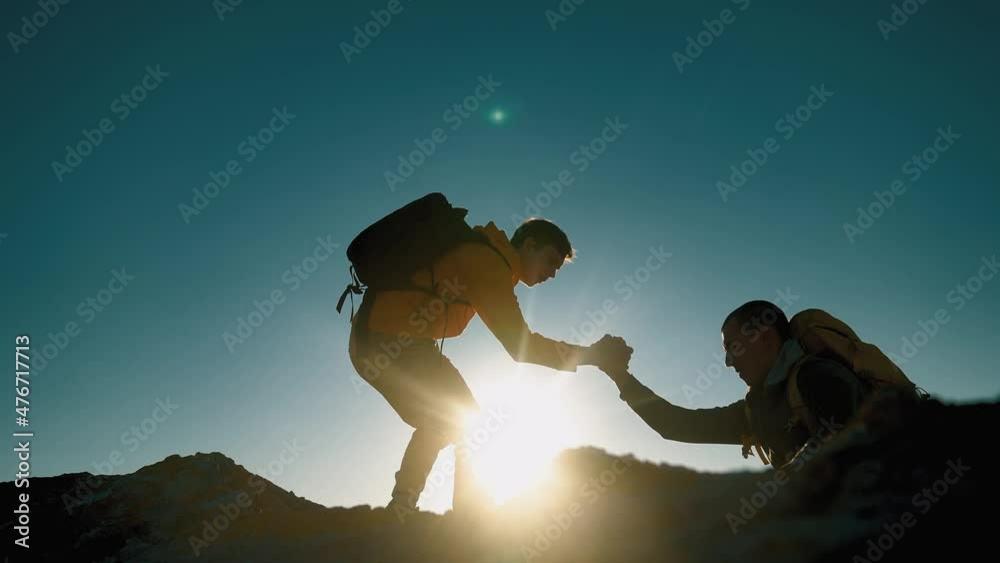 help team concept. team silhouette of two climber stretching a helping ...