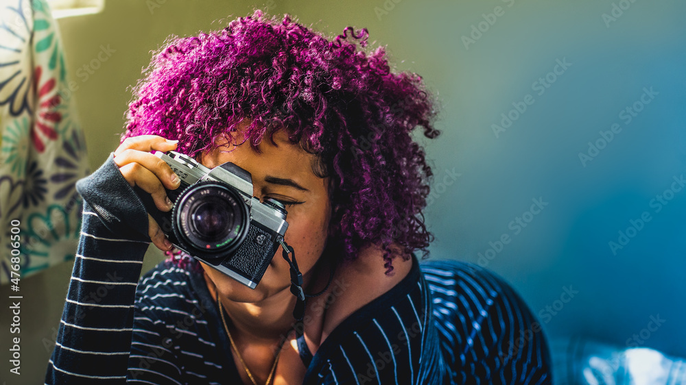 Girl who is dedicated to photography prepares from home to go to take ...