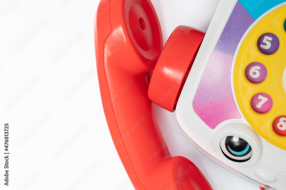 Children's toy landline phone with a red receiver, a dial and a smile ...