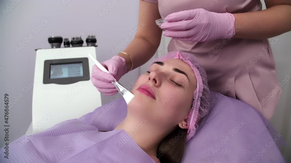 Beautiful woman receiving facial microcurrent treatment at spa salon ...