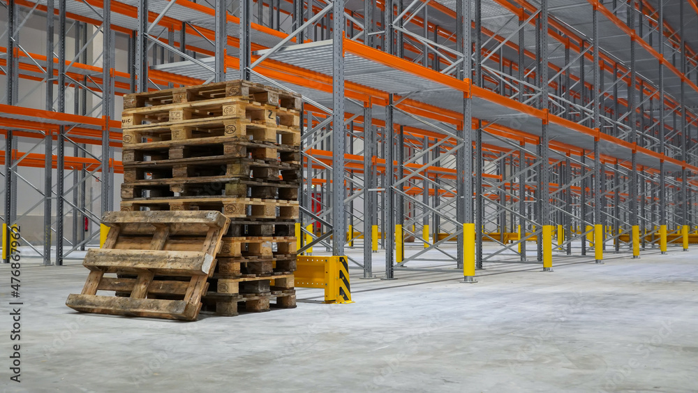 Empty stack pallets in logistics warehouse Stock Photo | Adobe Stock