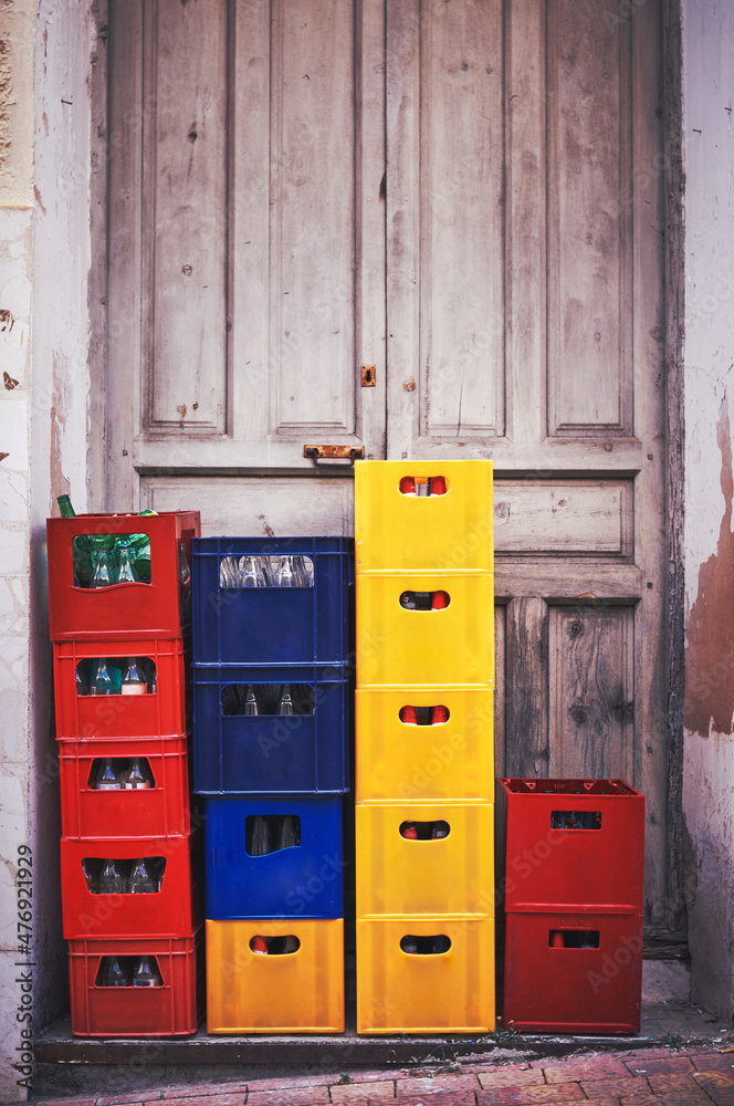 Stack of colored boxes with empty soda bottles for recycling in front ...