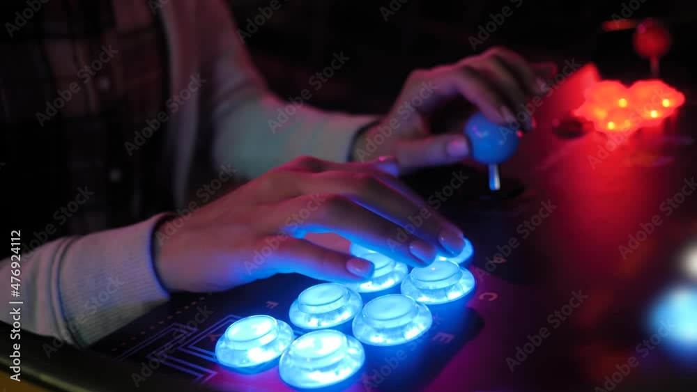 Close up: woman hands playing retro arcade machine game and pushing ...