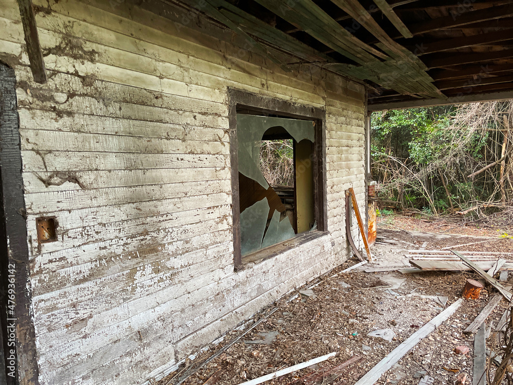 Old creepy scary wooden overgrown abandoned mansion side porch and ...