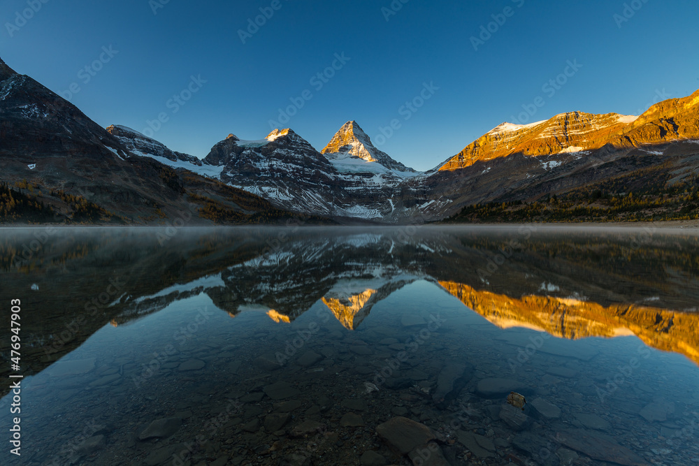 Mount Assiniboine and lake Magog sunrise in larch season Stock Photo ...