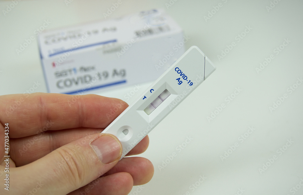 Showing a positive covid antigen test Stock Photo | Adobe Stock