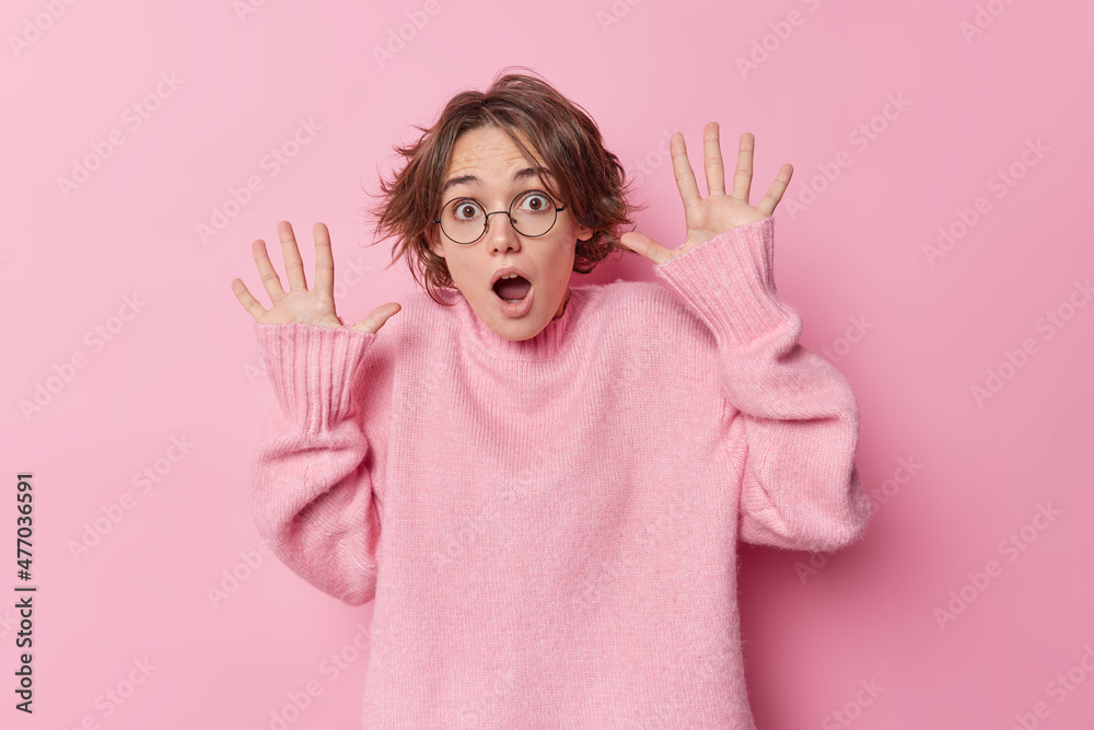 Scared woman has bob hairstyle looks with omg expression keeps mouth ...