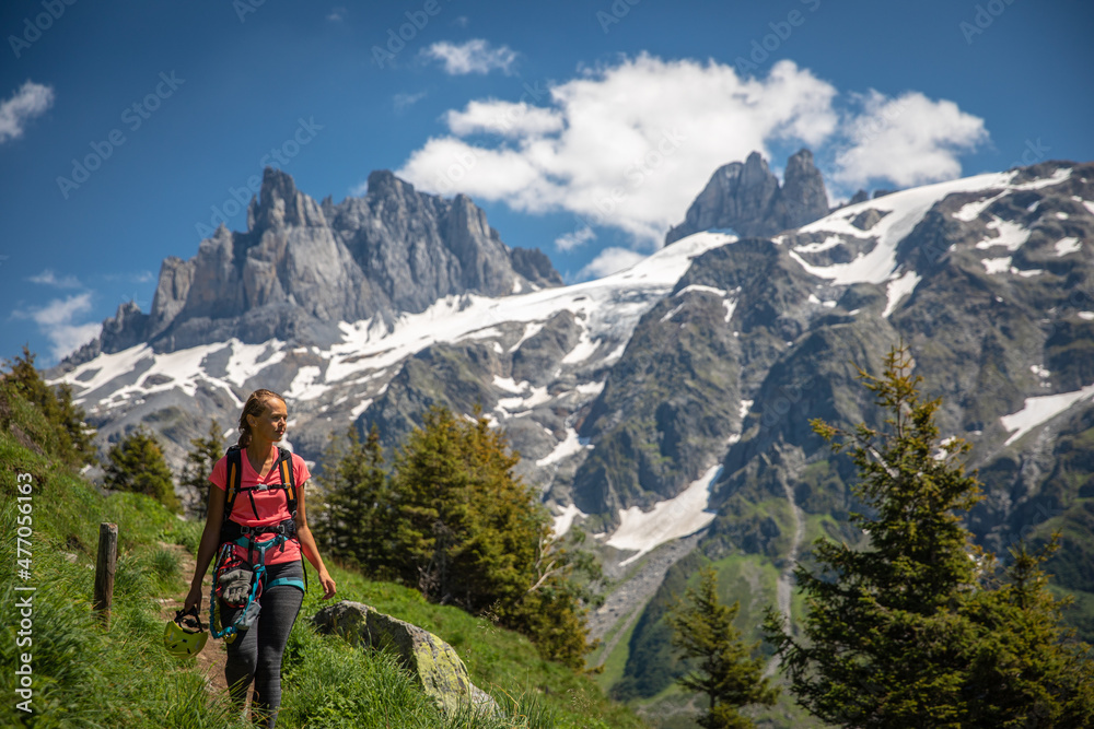 Pretty, female hiker/climber in a lovely alpine setting of Swiss Alps ...