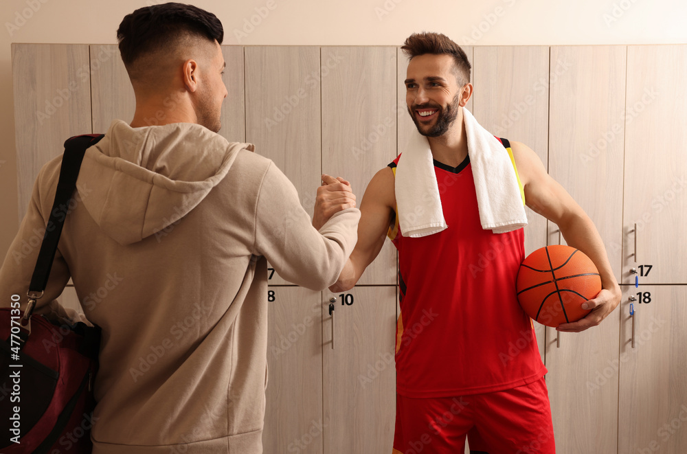 Handsome men greeting each other in locker room Stock Photo | Adobe Stock