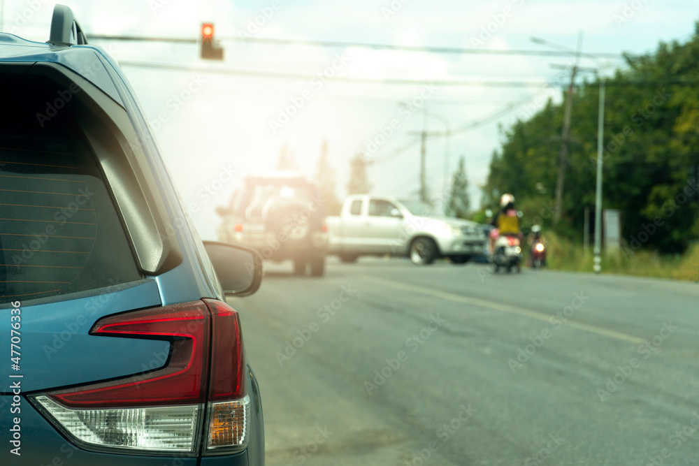 Rear side of blue car stop on the road in traffic junction. Various ...