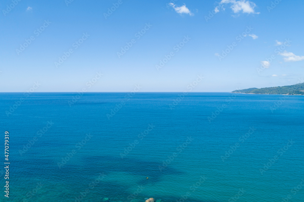 Aerial view of a blue sea surface water texture background and sun ...