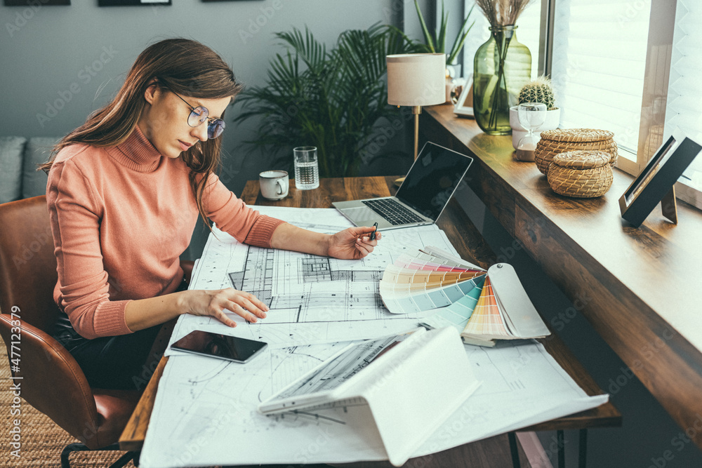 Female designer in office working on architects project. Woman ...